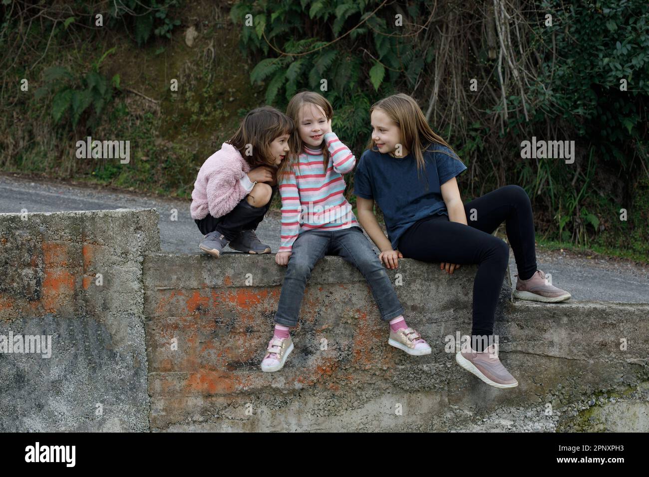Joyful children playing together outdoors. Young girls chatting Stock ...
