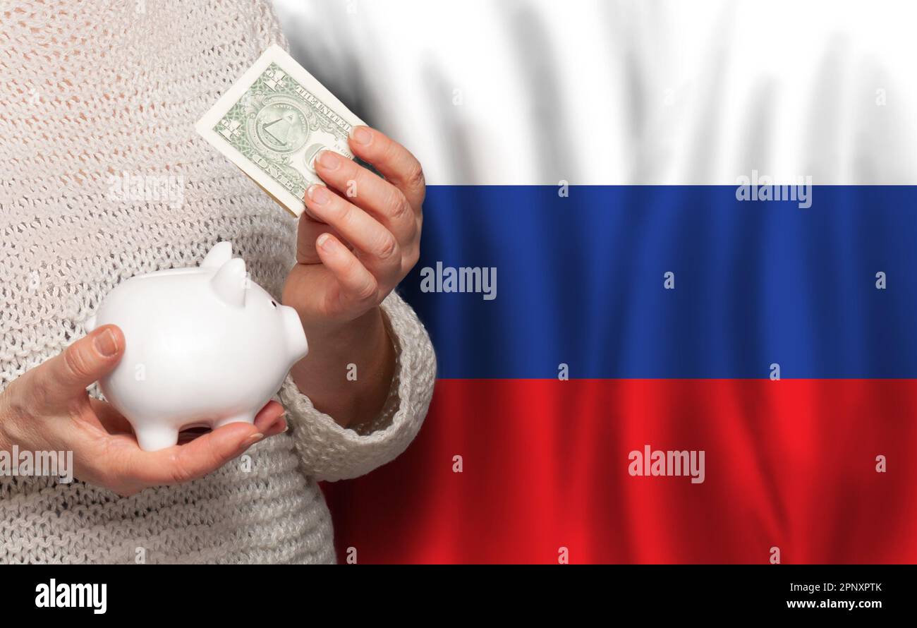 Russian woman with money bank on the background of Russia flag ...