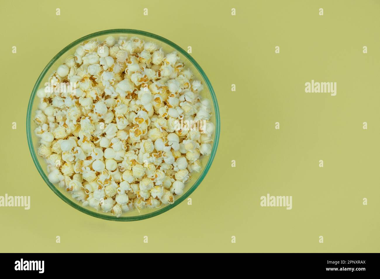 Popcorn large bowl on a yellow background. Fast food for cinema. Top ...