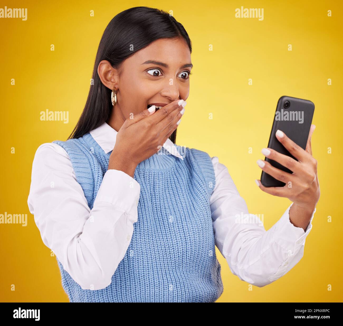 Wow, surprise and woman with phone in studio space reading text or ...