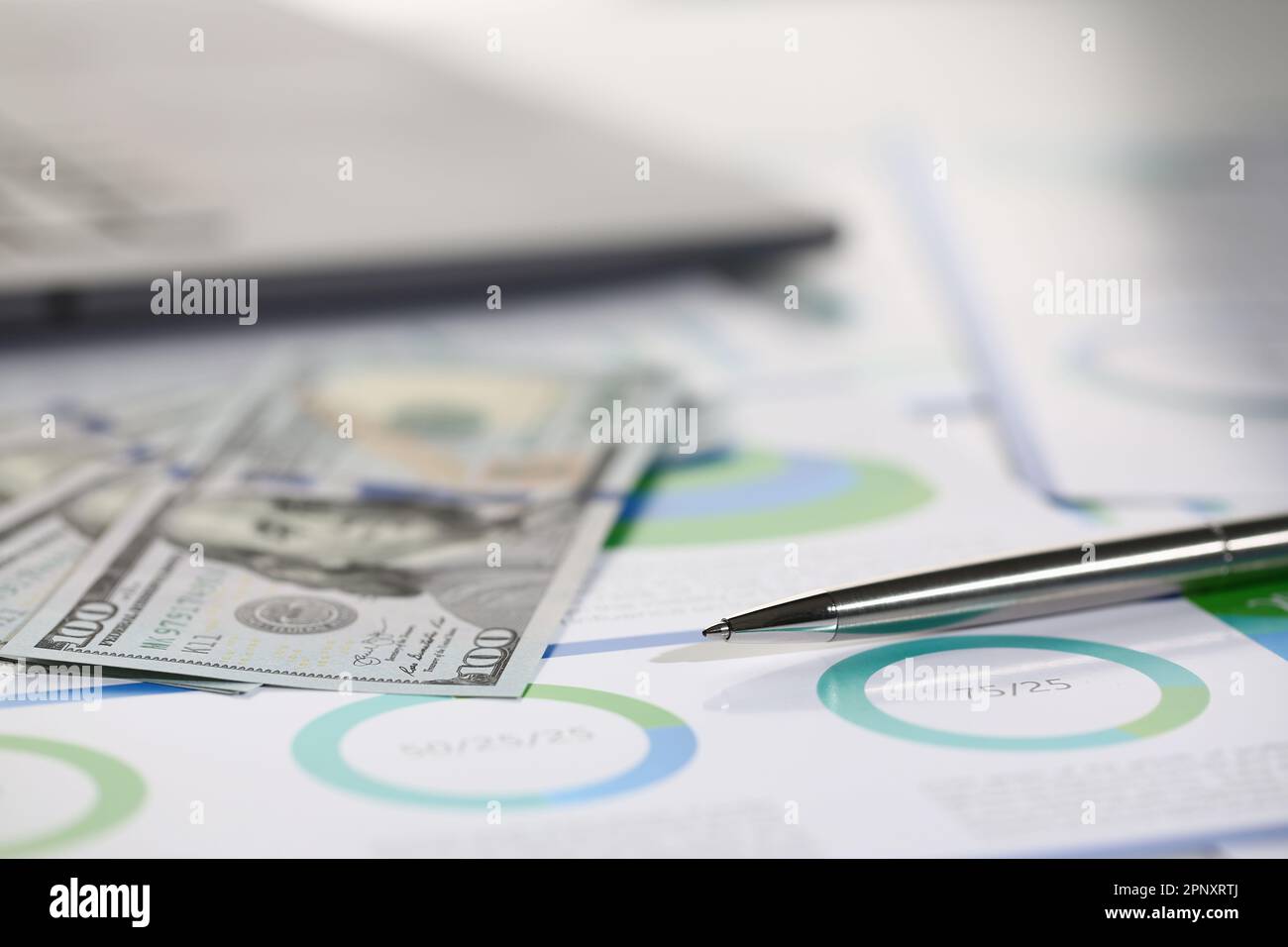 US dollar banknotes on chart with pen on desktop Stock Photo - Alamy