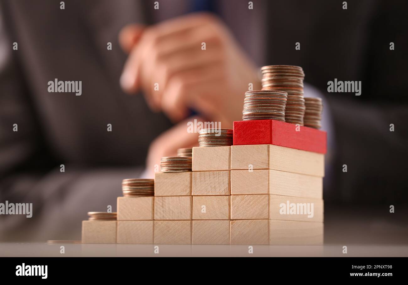 Wooden blocks with coins growing stacked and stacked in increasing ...