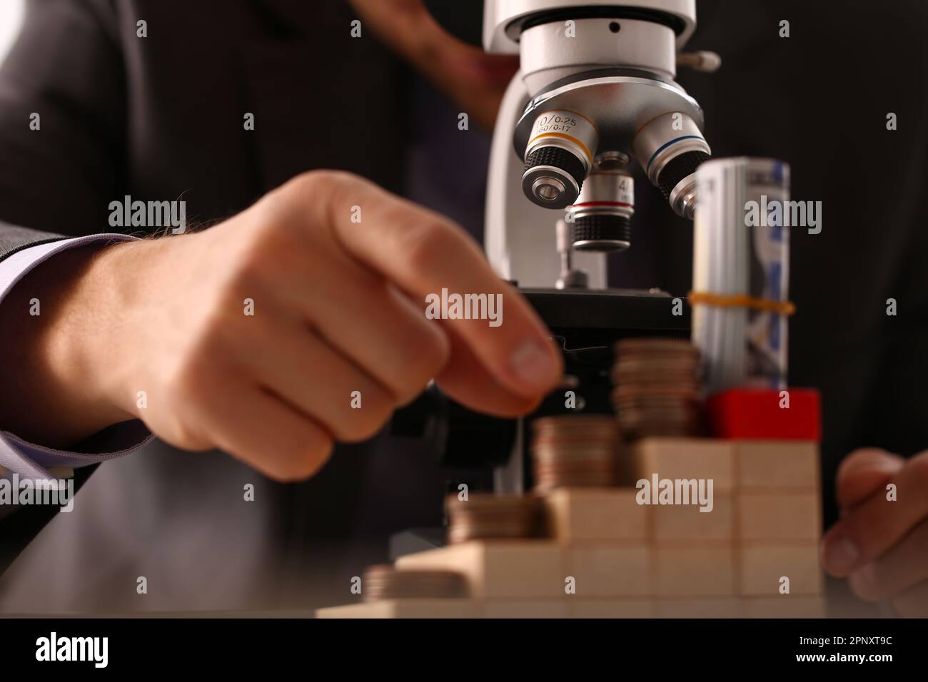 Hand microscope coin hi-res stock photography and images - Alamy