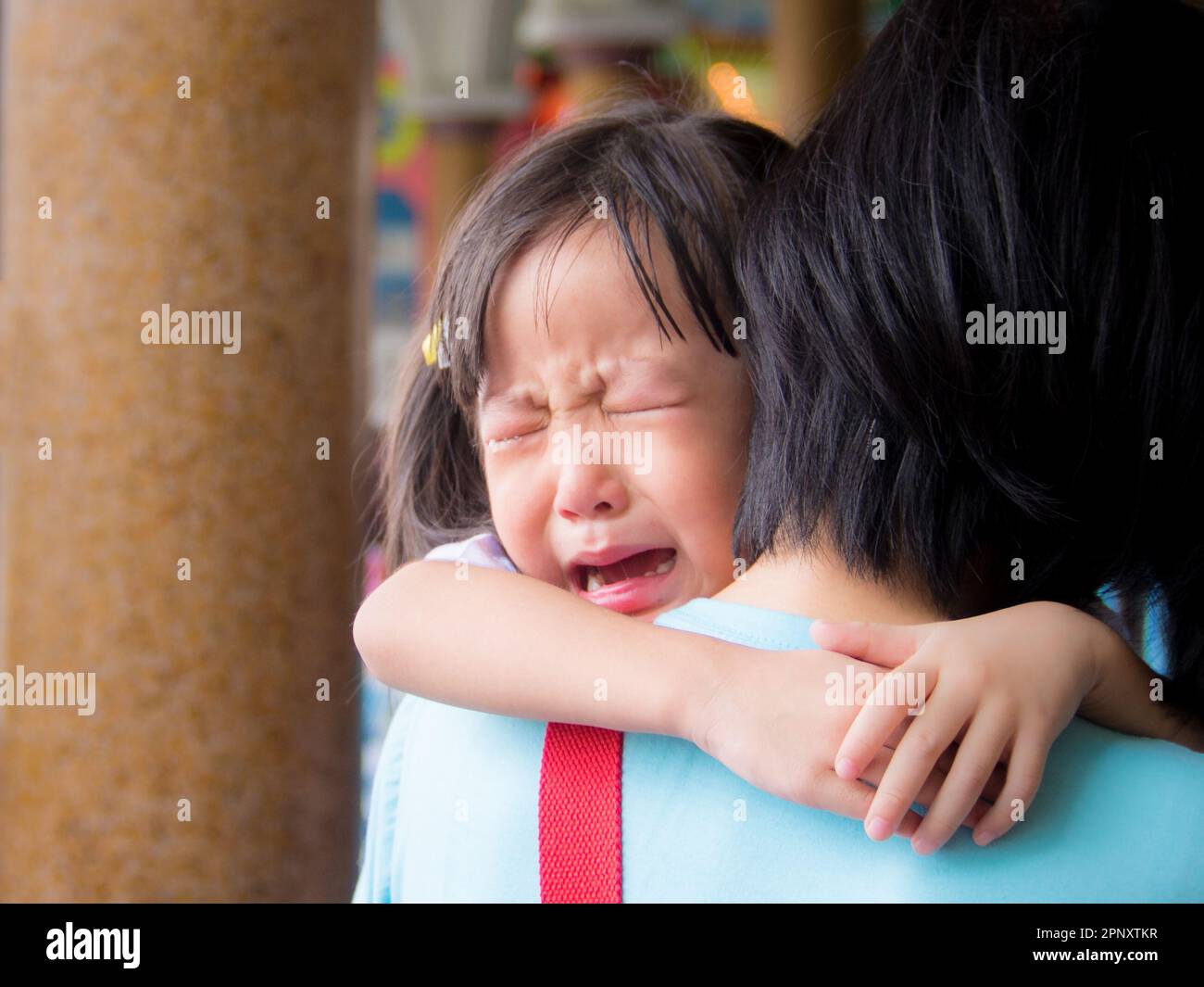Asian baby girl hugging her mother crying Stock Photo - Alamy