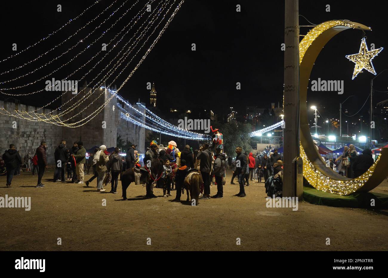 Palestinians gather in front of Damascus Gate on the eve of Eid al-Fitr ...