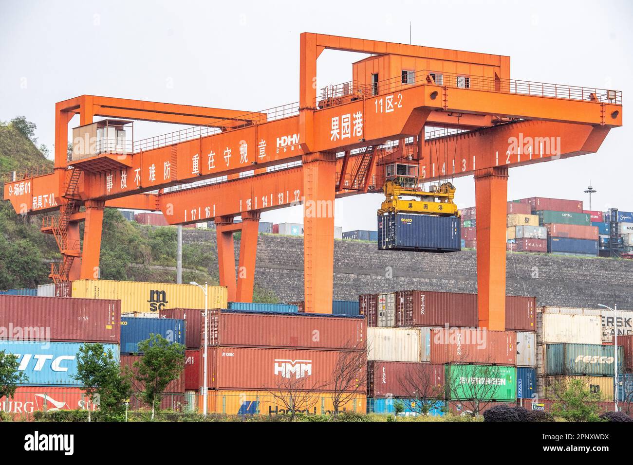 Chongqing. 20th Apr, 2023. A crane lifts a shipping container at ...
