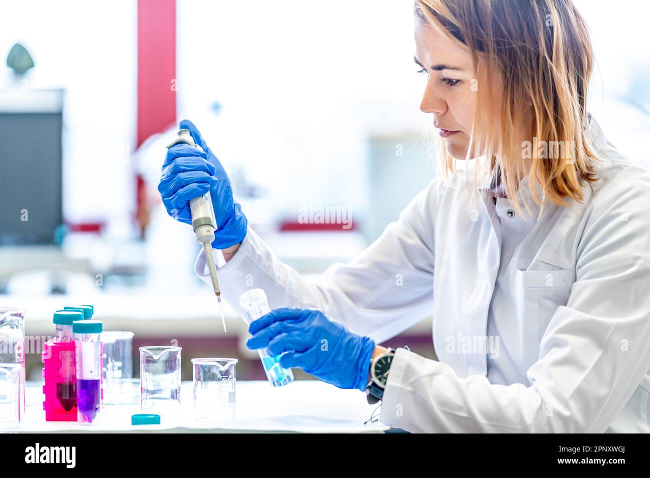 mixing of chemical substances by a young female scientist in a ...