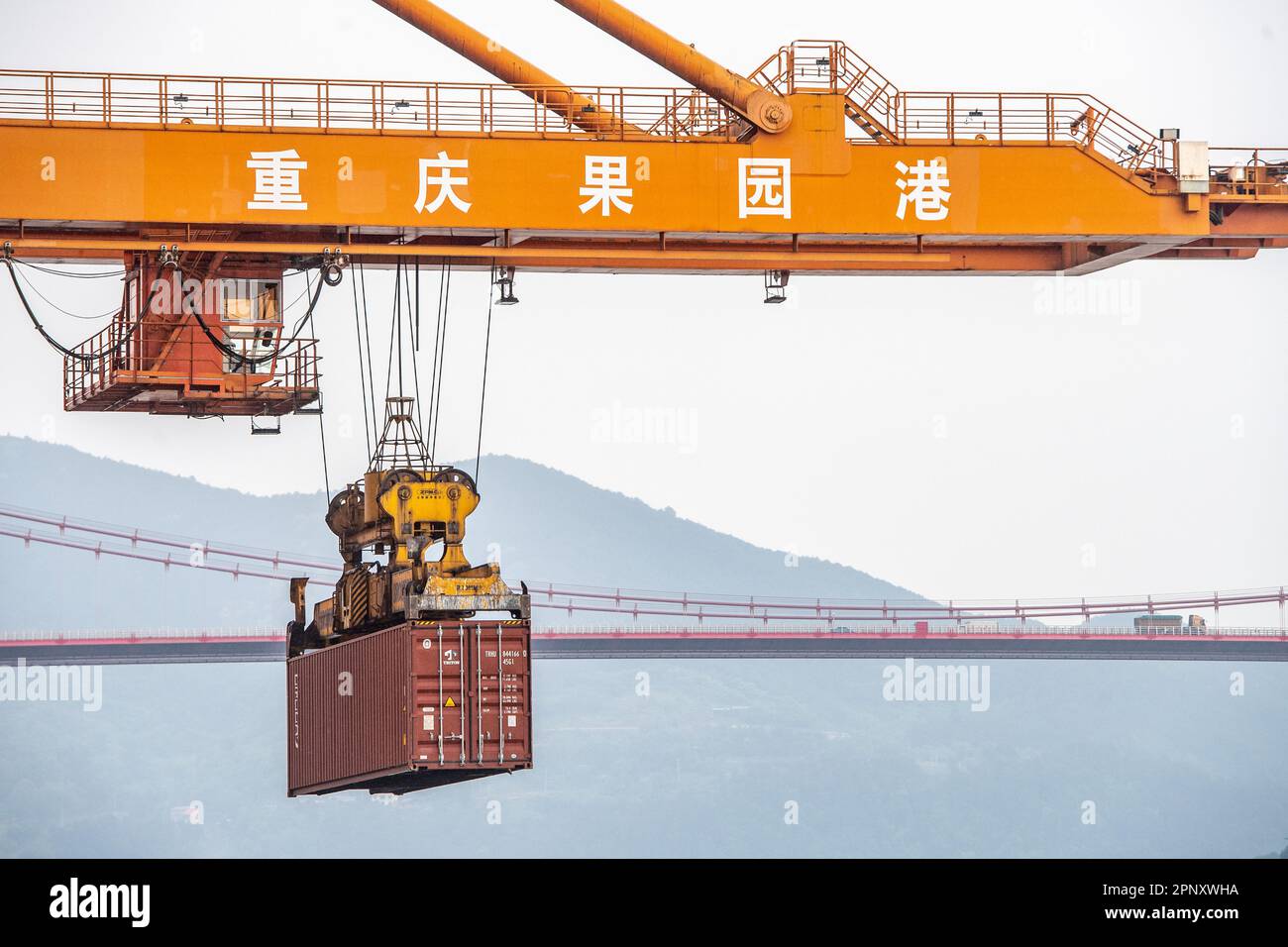 Chongqing. 20th Apr, 2023. A crane lifts a shipping container at ...