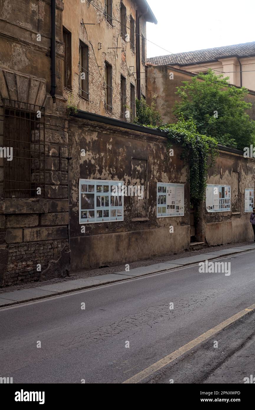 Facade of an abandoned building with a creeping plant on it in a street ...