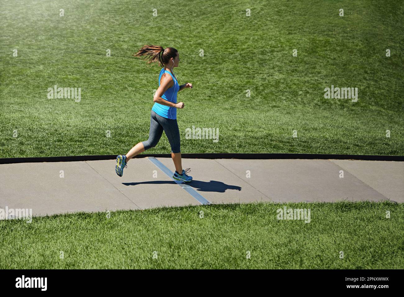 Going until she cant go no more. a young woman listening to music while ...