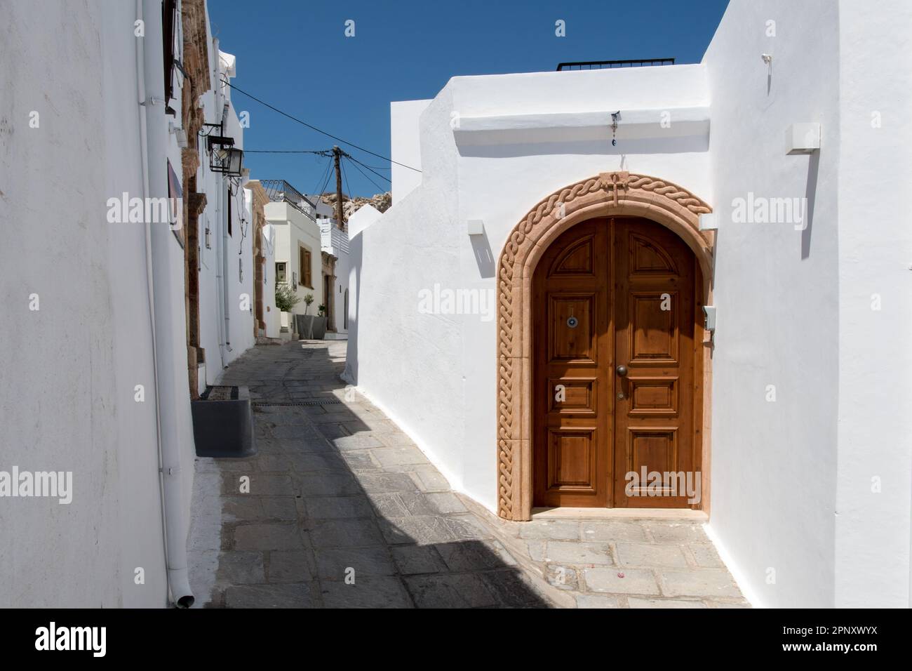 Narrow Street in Lindos town on Rhodes Island Stock Photo - Alamy