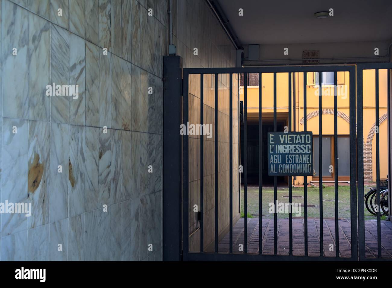 Covered entrance of a condominium closed by a gate Stock Photo - Alamy