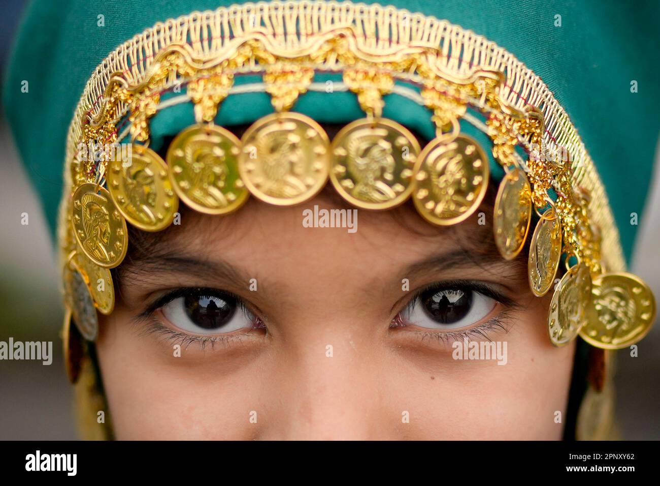 A little girl poses for a portrait after Eid Al-Fitr prayers in ...