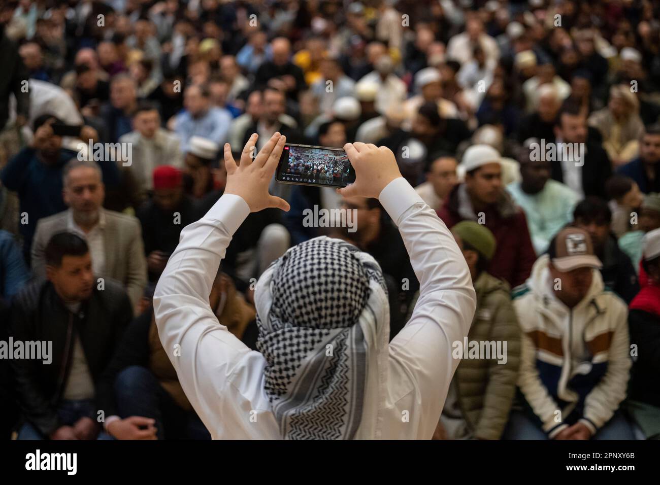 A boy streams live video on social media before Eid Al-Fitr prayers in ...