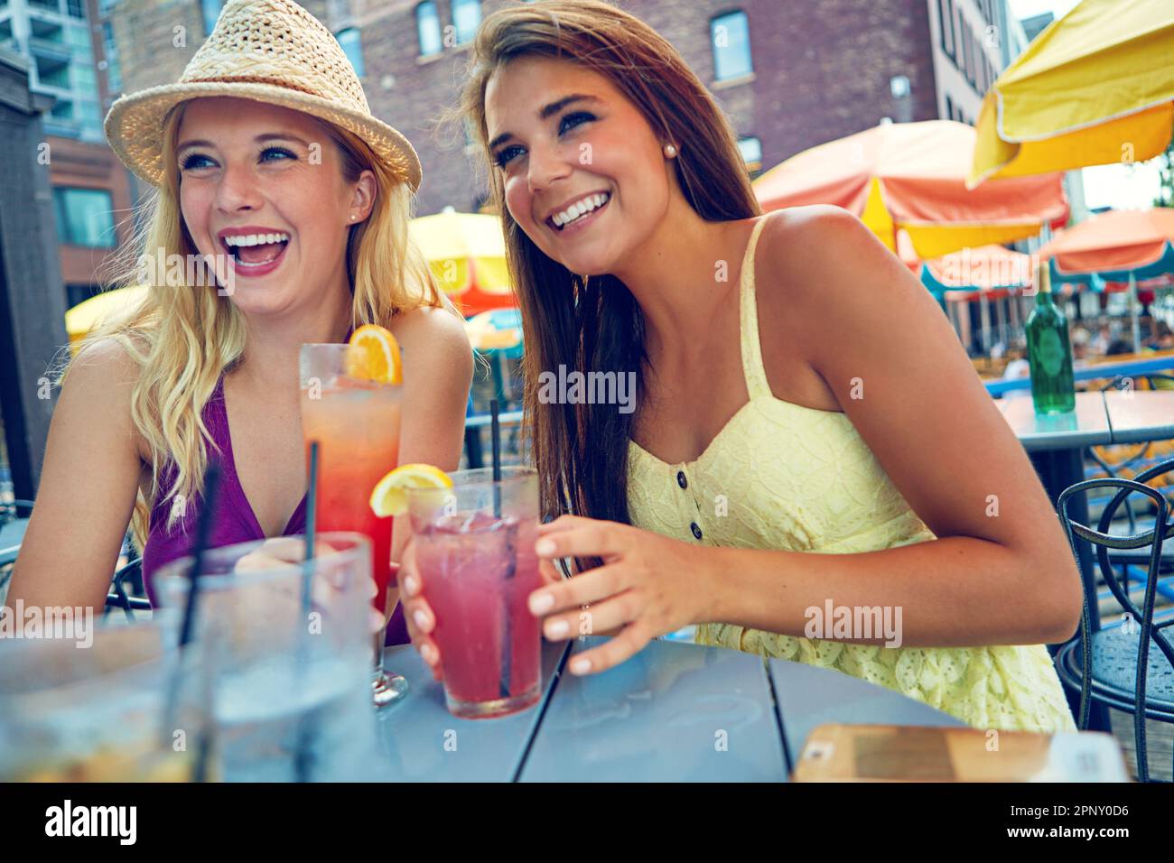 Getting their drink on at the cafe. two attractive young women sitting ...