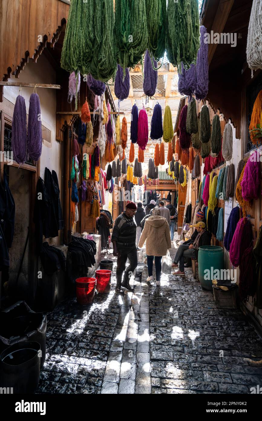Dyed wool of different colors hanging in a street in the medina of Fez ...