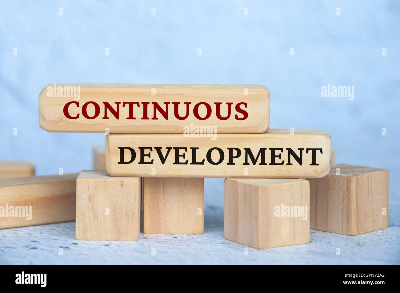 Continuous development text on wooden blocks with blur cover background. Operational excellence ...