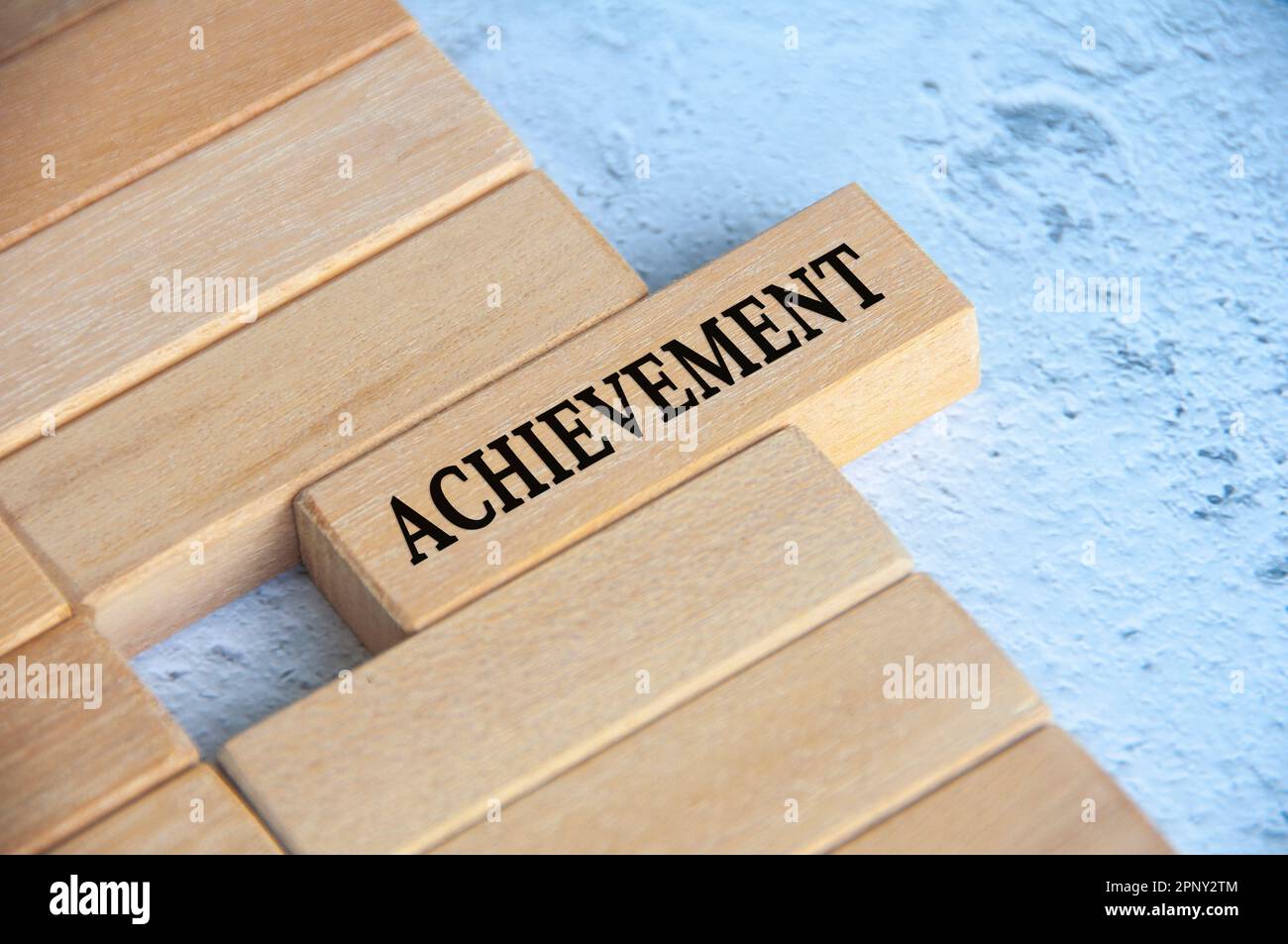 Top view of achievement text on wooden blocks. Business culture and ...