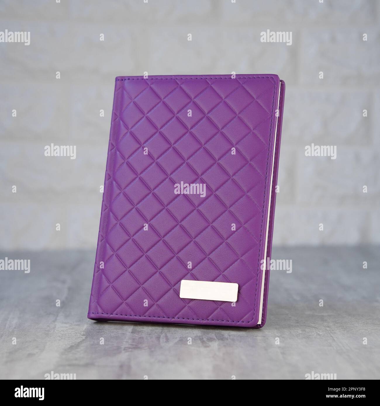 A purple passport cover on a wooden table surface Stock Photo - Alamy