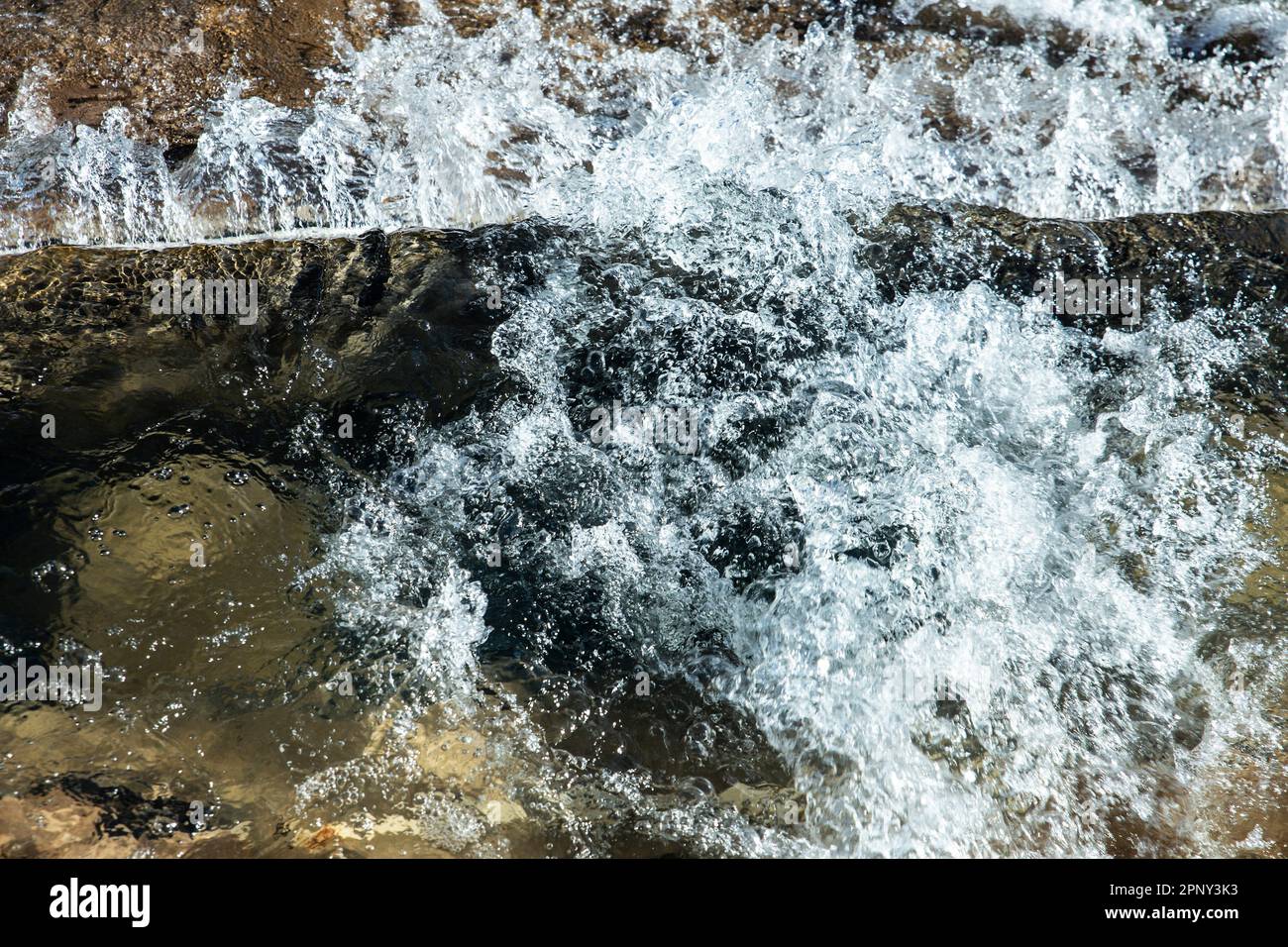 top view of surface of the water agitated on the rocks Stock Photo - Alamy