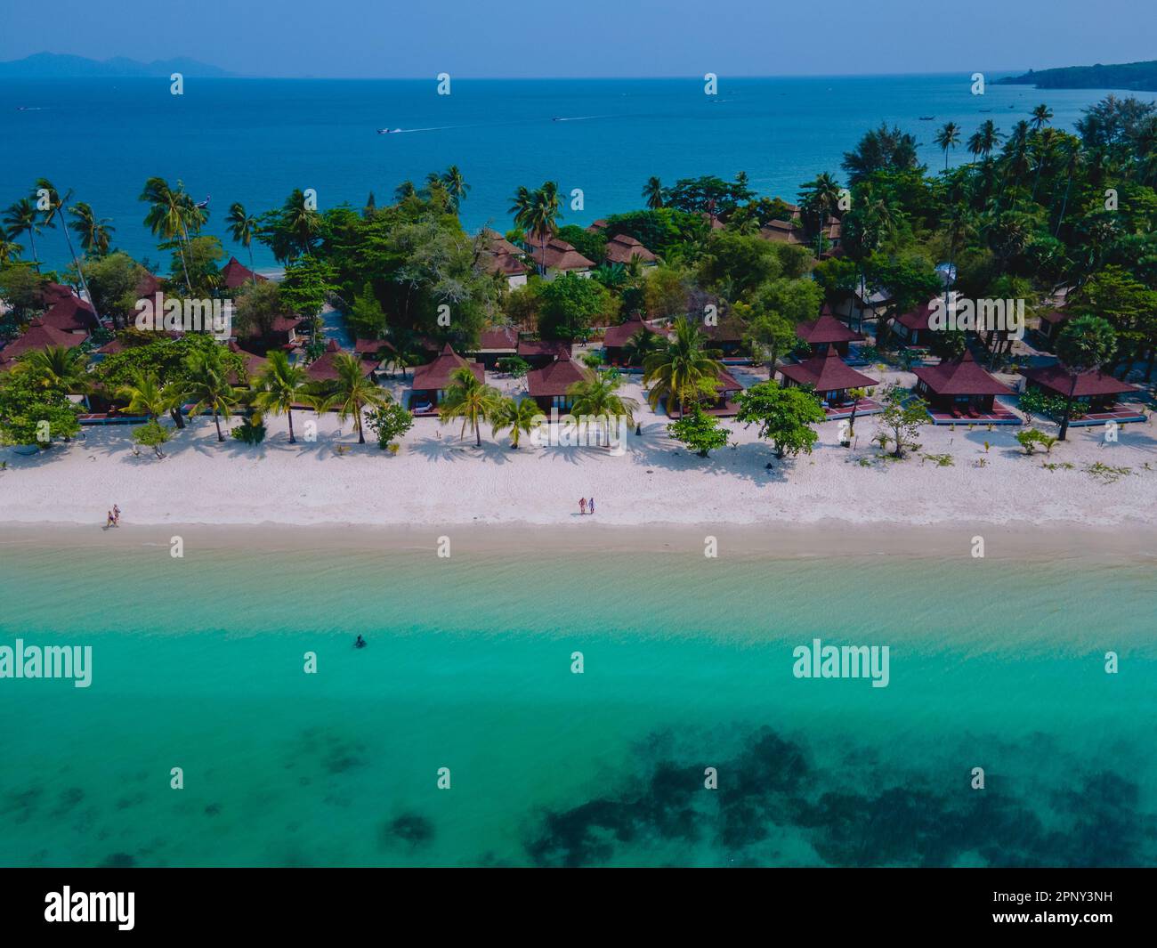 A couple of men and women on vacation at Koh Mook tropical Island in ...
