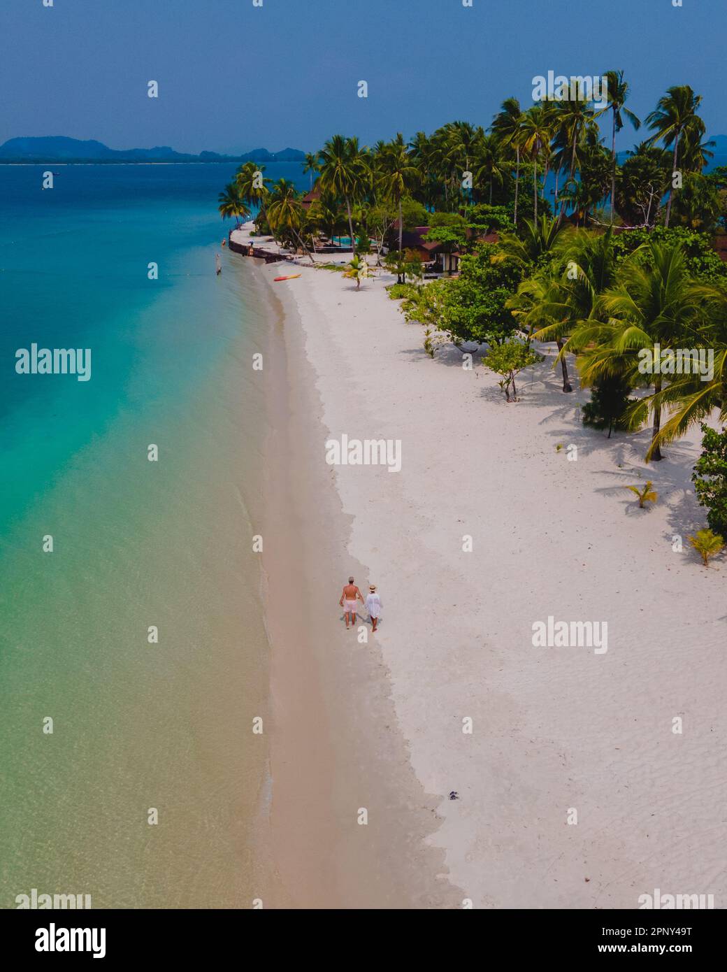 A couple of men and women on vacation at Koh Mook tropical Island in ...