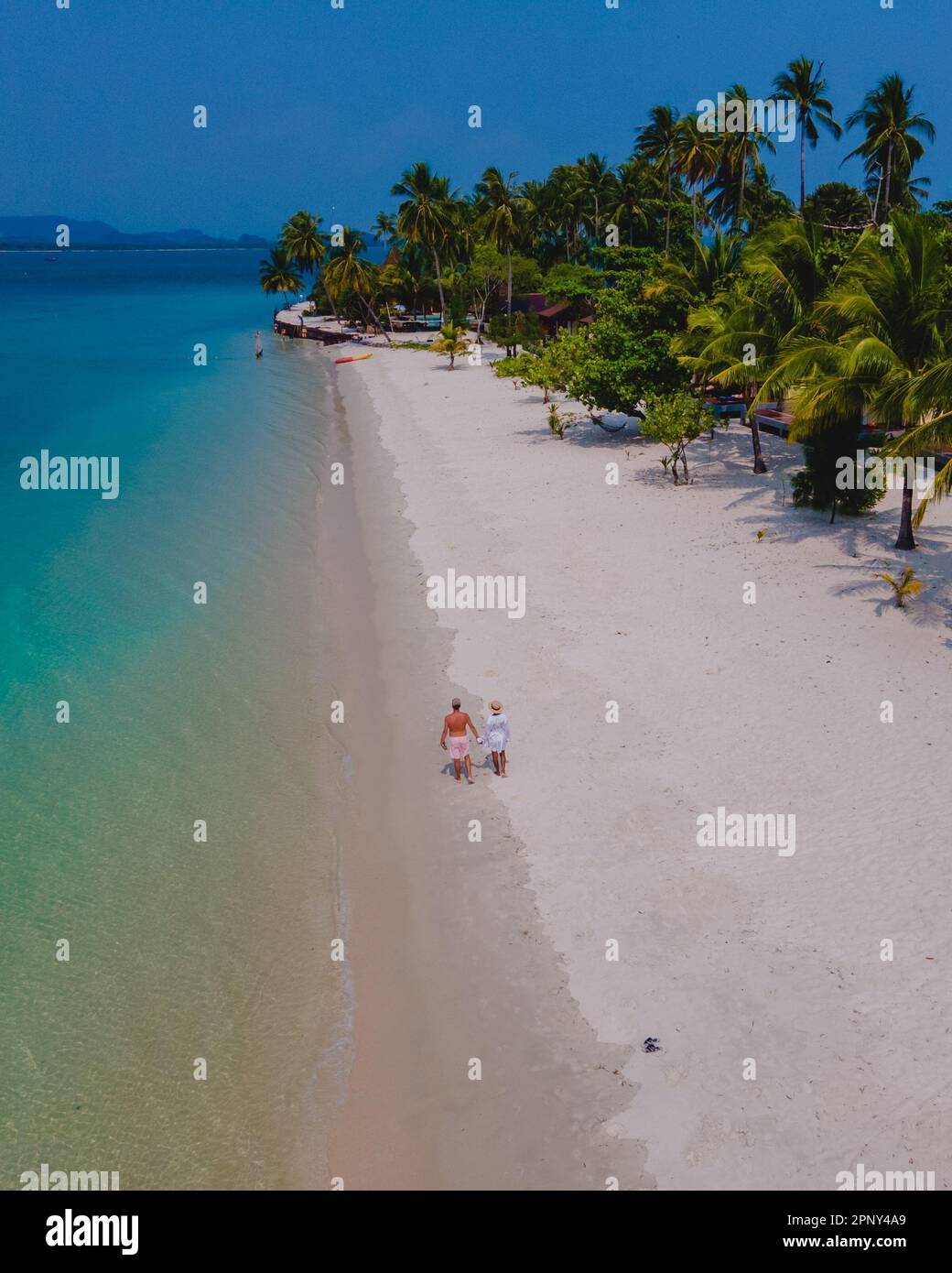 A couple of men and women on vacation at Koh Mook tropical Island in ...