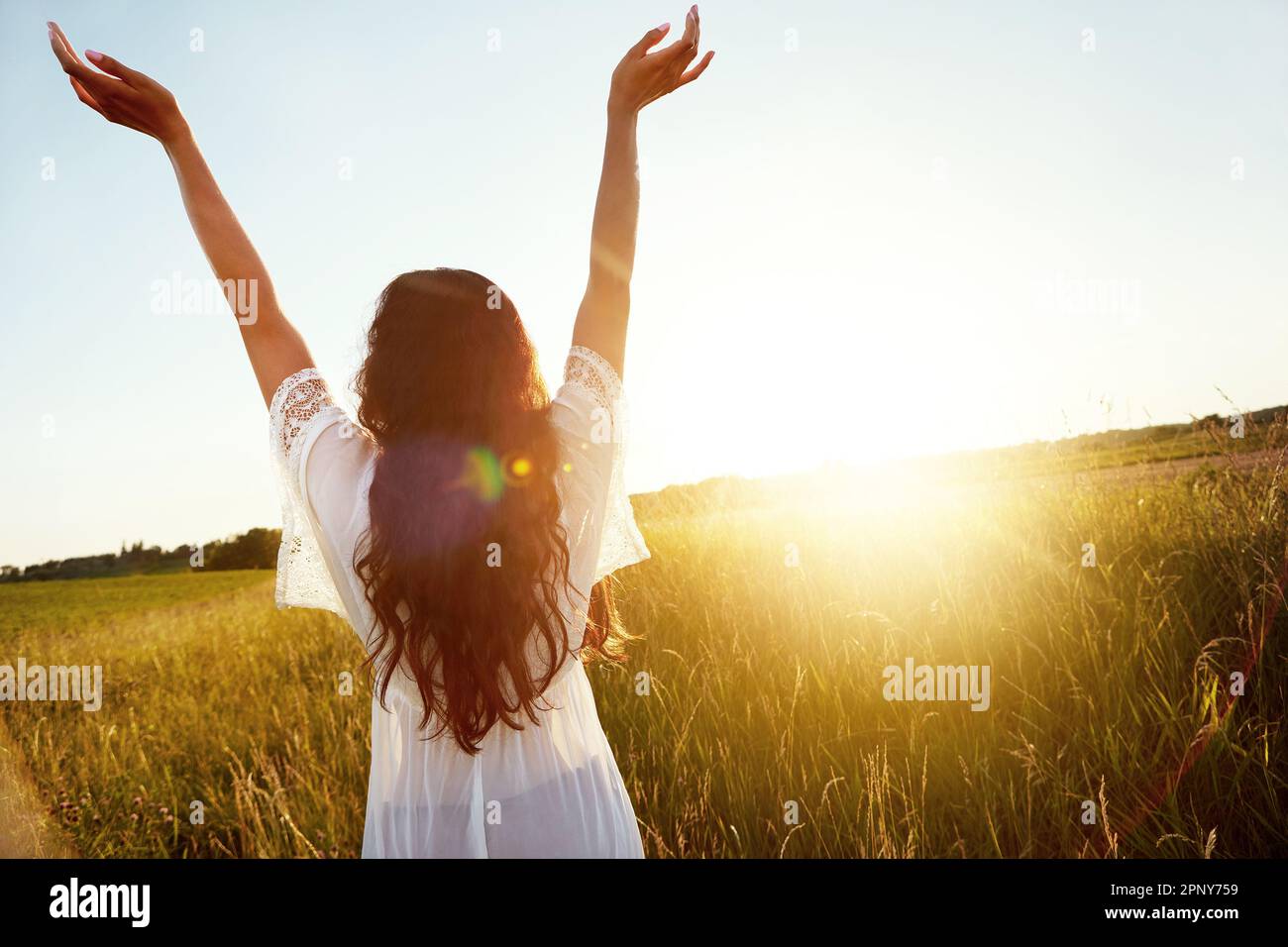 Celebrating summer. an attractive young woman standing outside in a ...