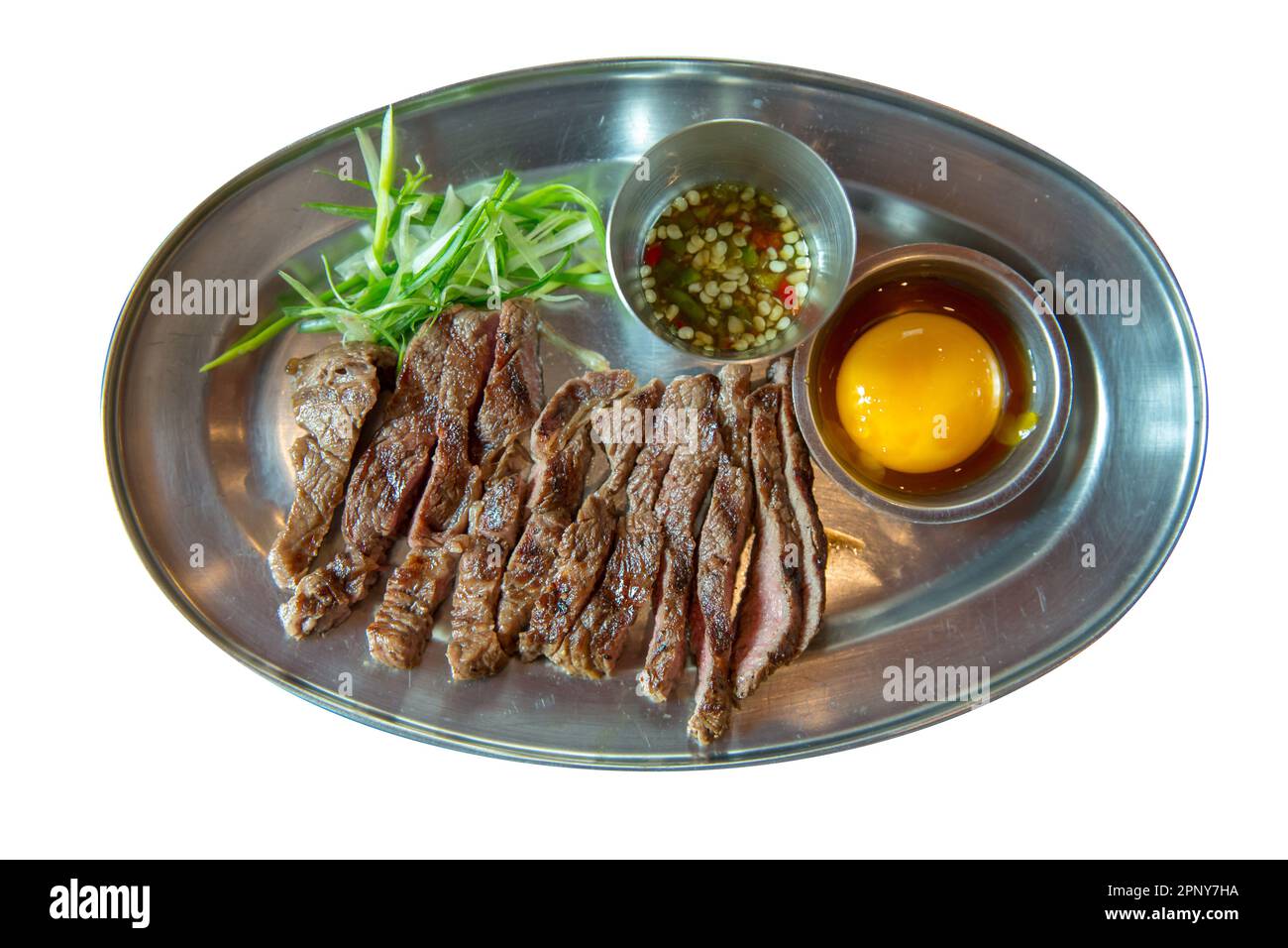 Die cut of Sirloin beef topped with fish sauce and fresh egg and onion ...