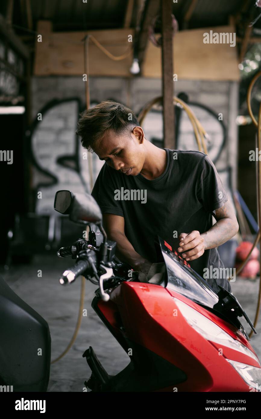 Asian man washing motorbike with soap at service station Stock Photo ...