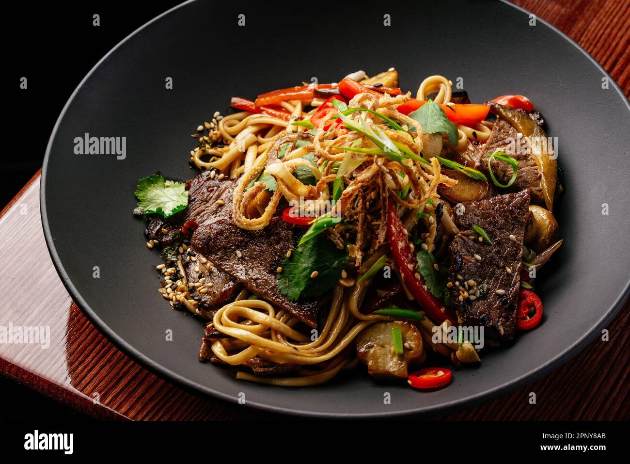 asian noodles with beef and vegetables. restaurant menu Stock Photo - Alamy