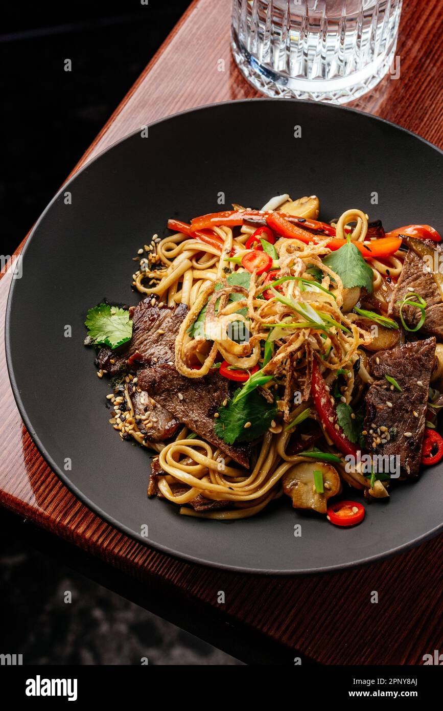 asian noodles with beef and vegetables. restaurant menu Stock Photo - Alamy