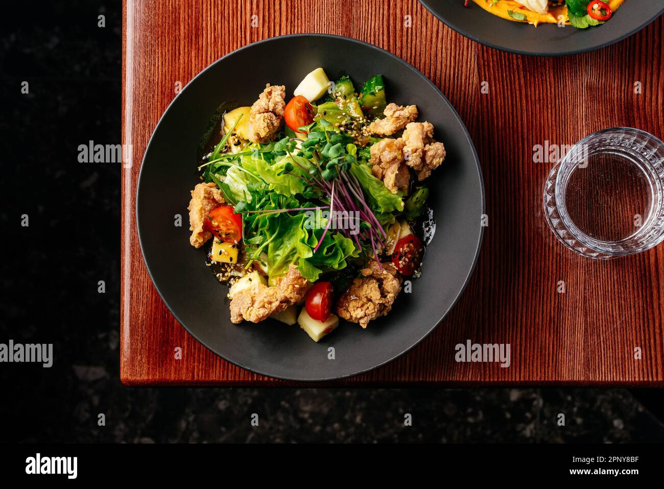 warm salad with chicken, vegetables and herbs. restaurant menu Stock ...