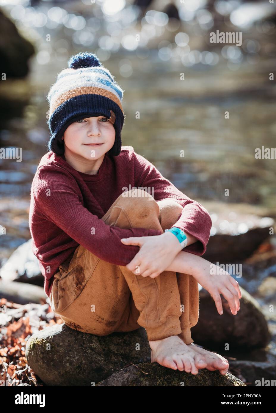 Portrait of young boy on rocks in nature Stock Photo - Alamy