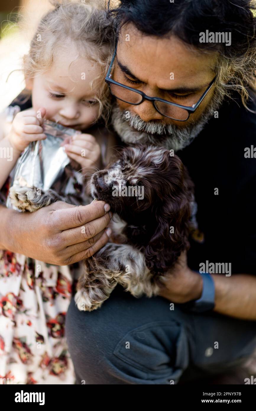 Uncle & Niece Holding Puppy in San Diego Stock Photo - Alamy