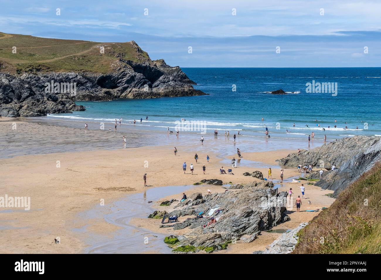 Holidaymakers tourists visitors on the secluded rugged Polly Porth Joke ...