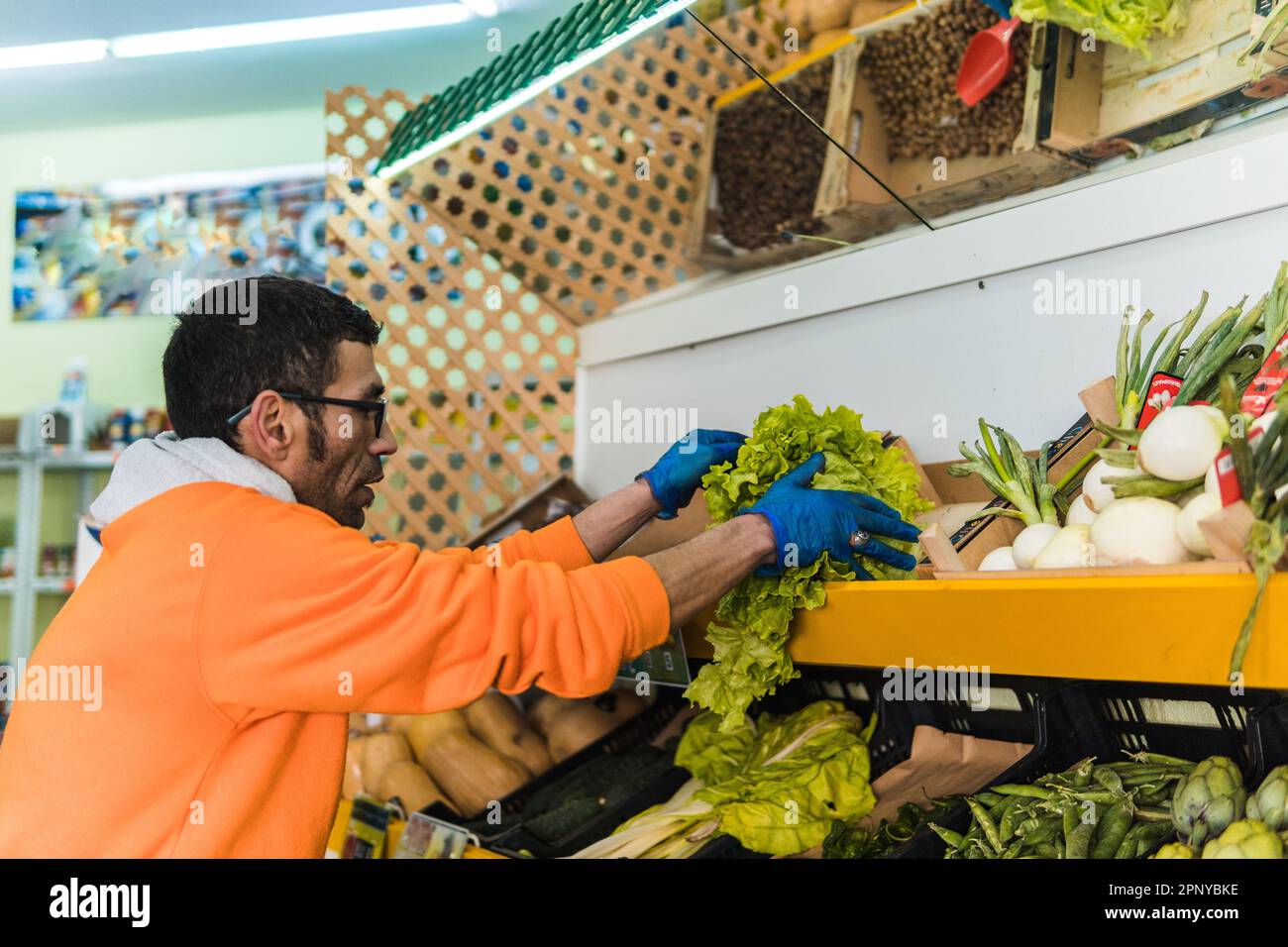 arab man placing lettuce in his greengrocer Stock Photo - Alamy