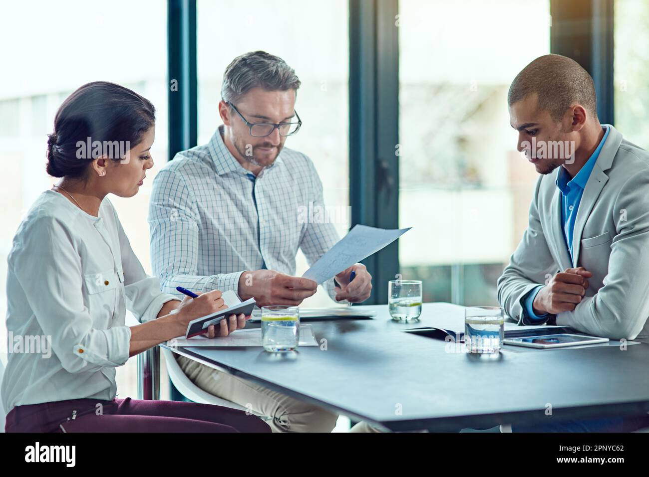 Coming up with a plan of action. colleagues having a meeting in an ...