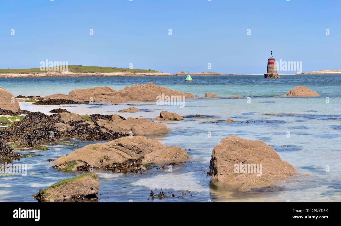 rocky beach view with boats and beacon background in aber Benoit ...