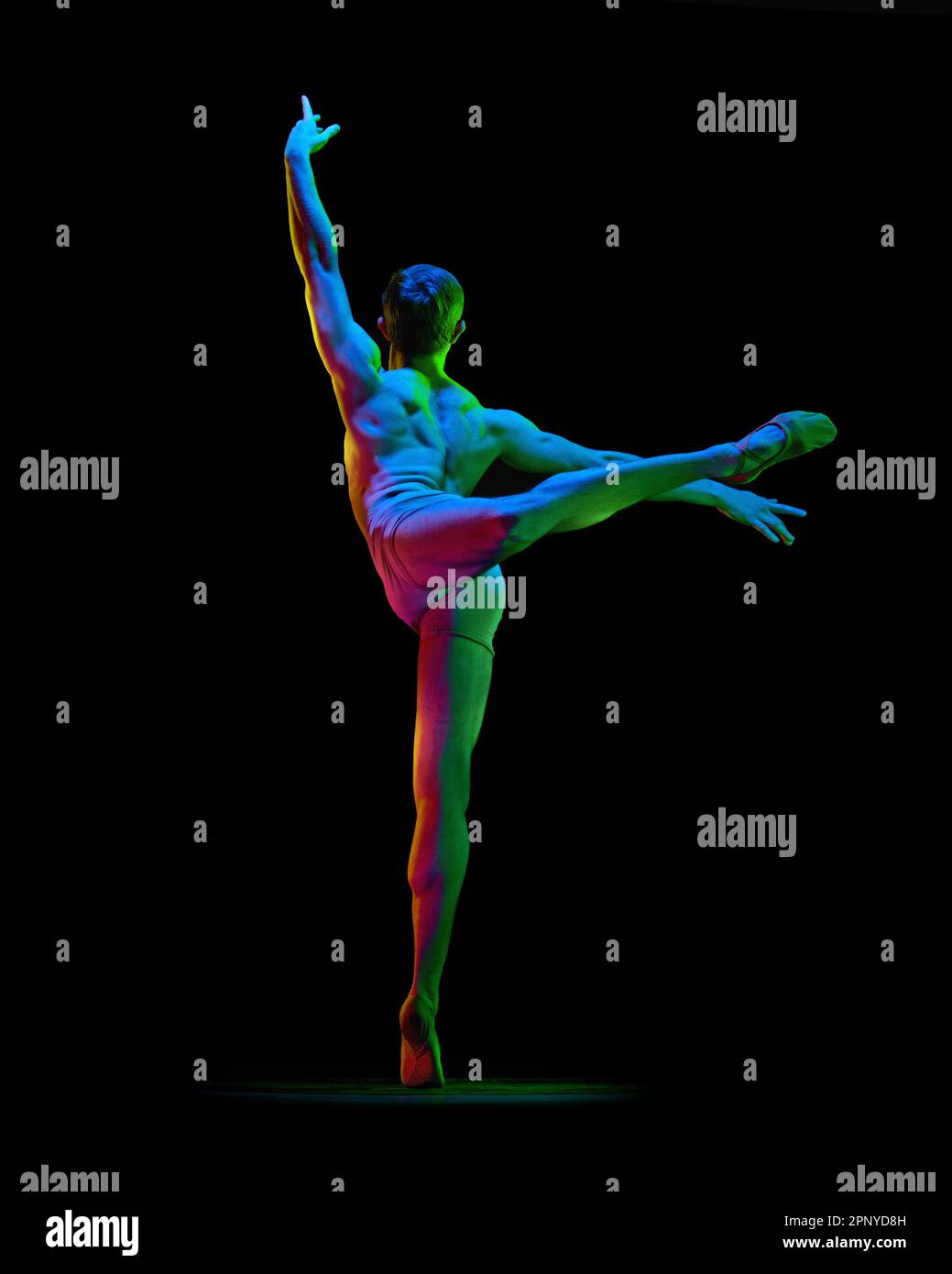 Portrait of handsome muscled male ballet dancer dancing over dark ...