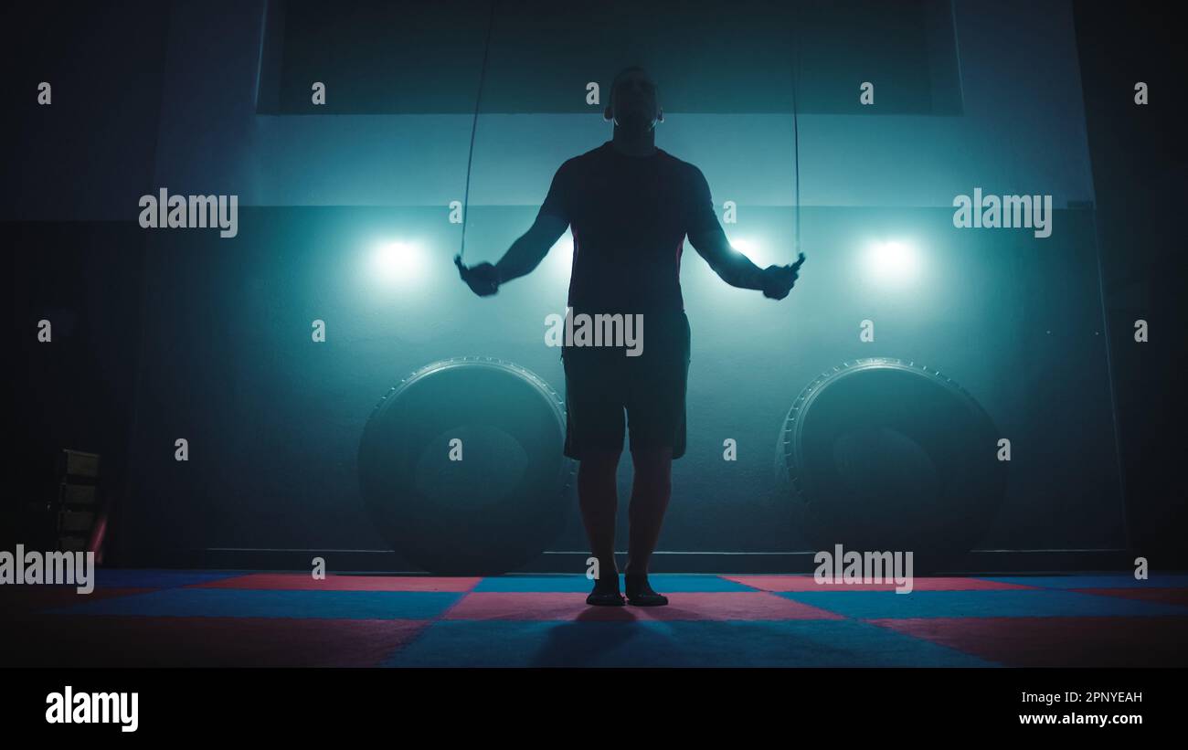 Man using a jumping rope to improve muscle strength Stock Photo - Alamy