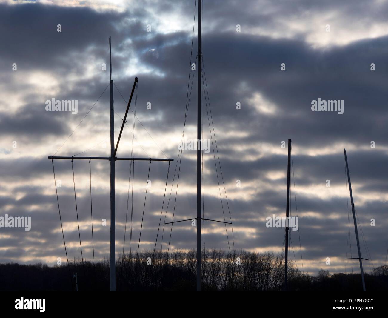 Dark, glowering overcast sky; an abstract array of yacht masts and ...