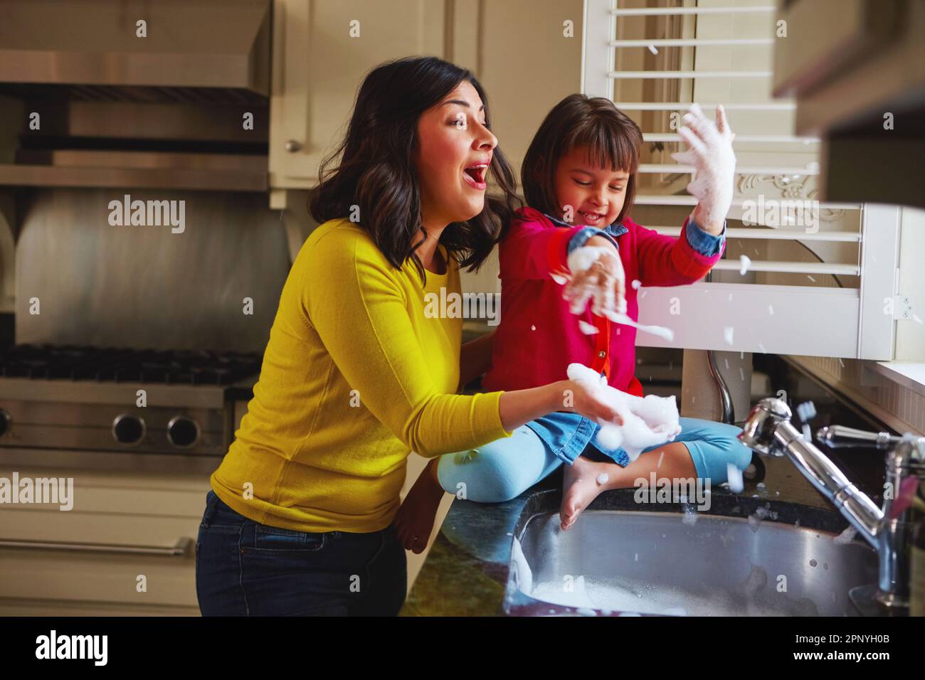 Washing up is serious business. a young mother and her daughter playing ...