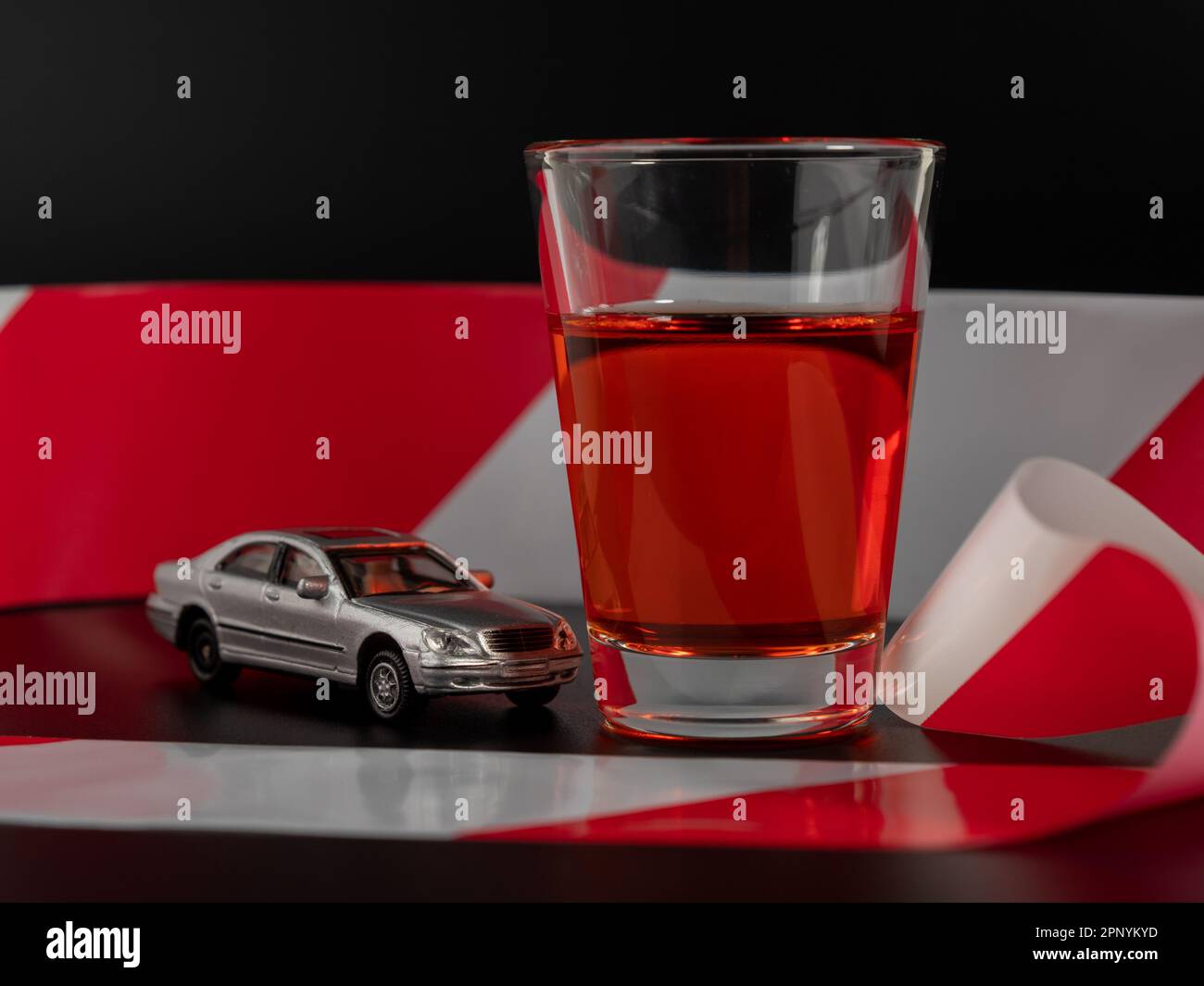 Mini car accident. Alcohol and a toy car on a black background. Drunk ...