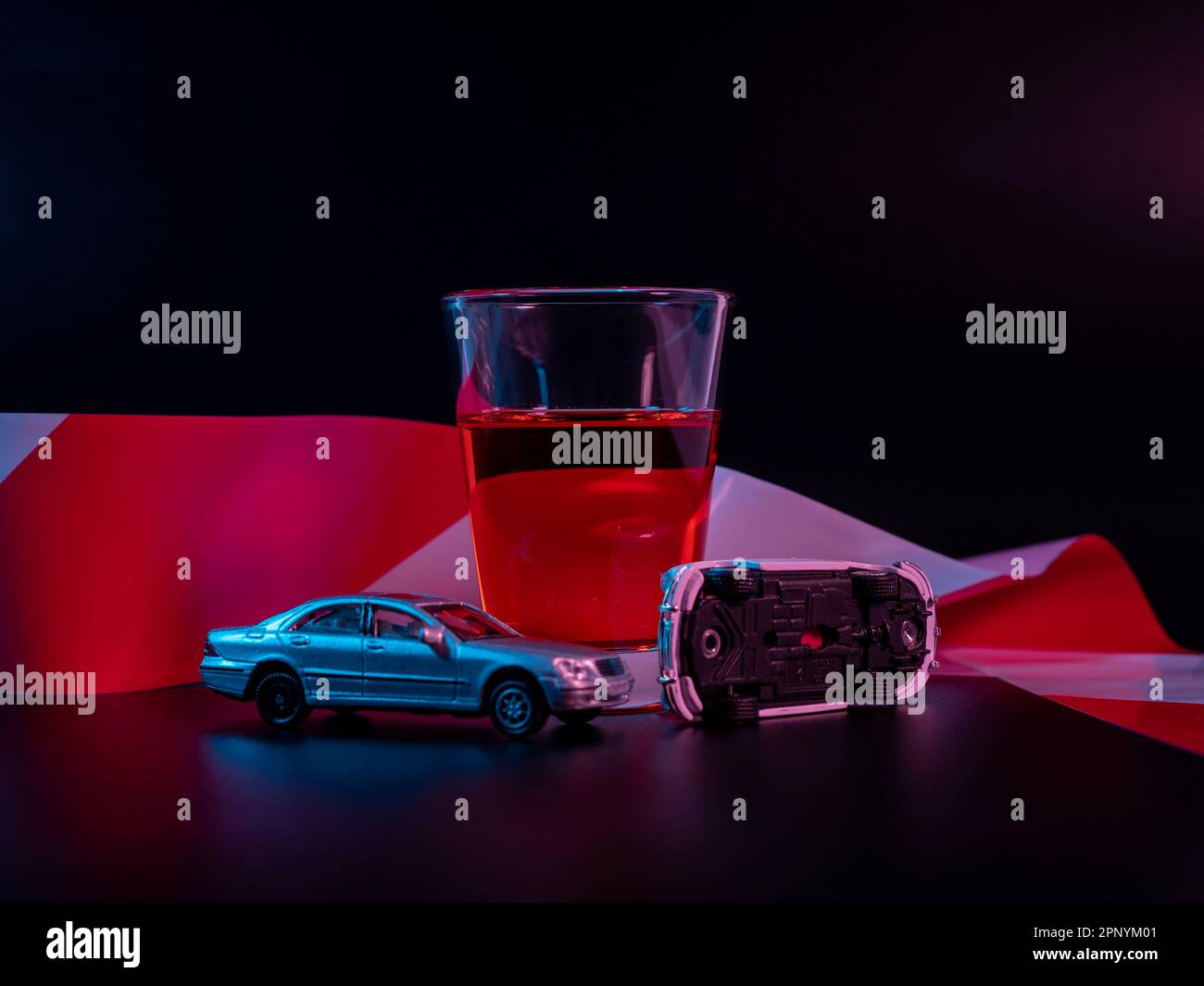 Mini car accident. Alcohol and a toy car on a black background. Drunk ...