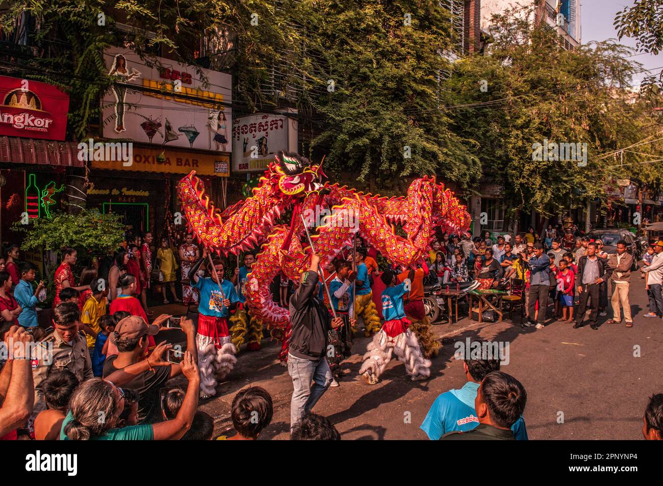 a crowd watches traditional "dragon dancing" during Chinese New Year ...