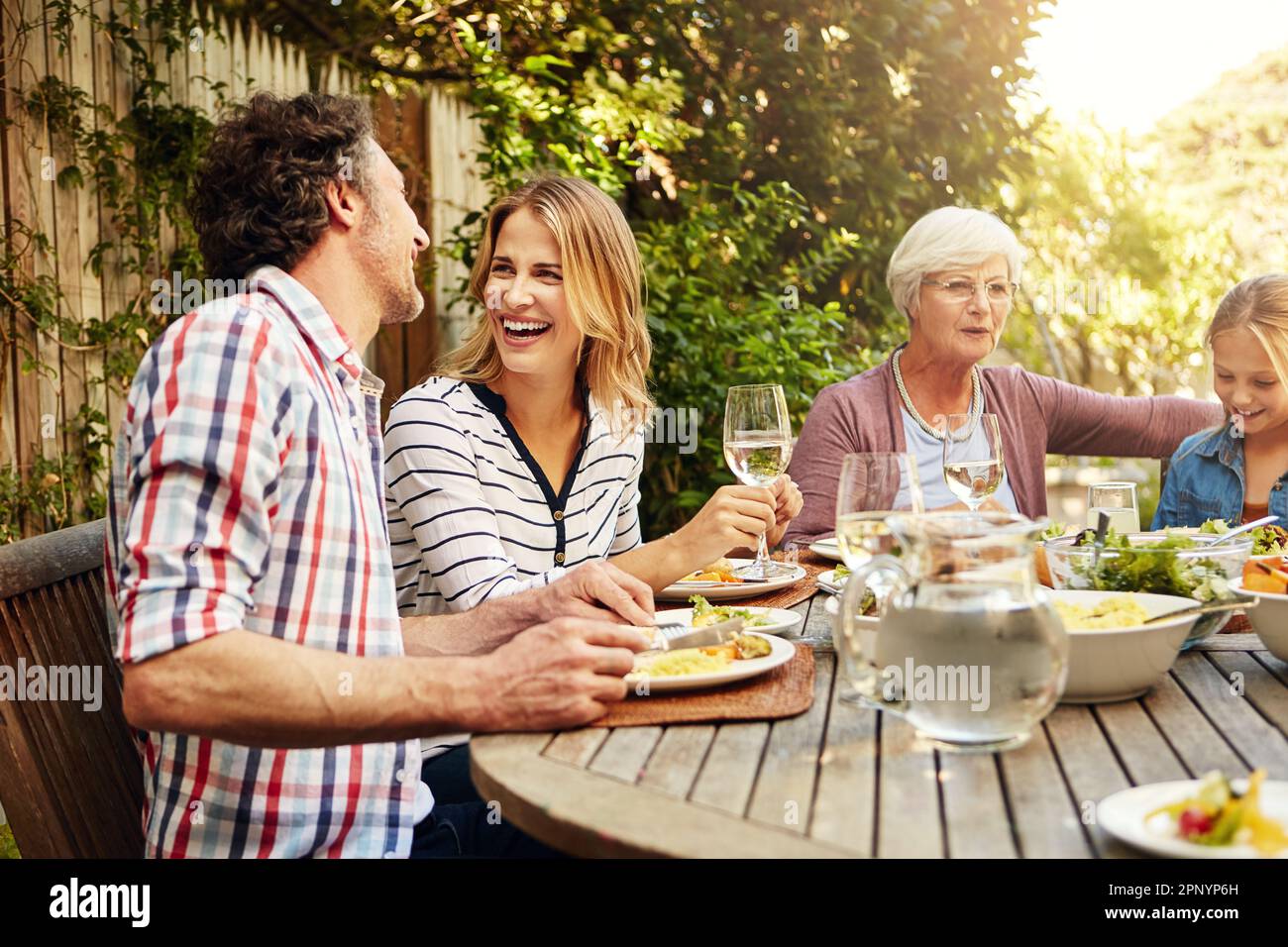 Family food fun. a family eating lunch together outdoors Stock Photo ...