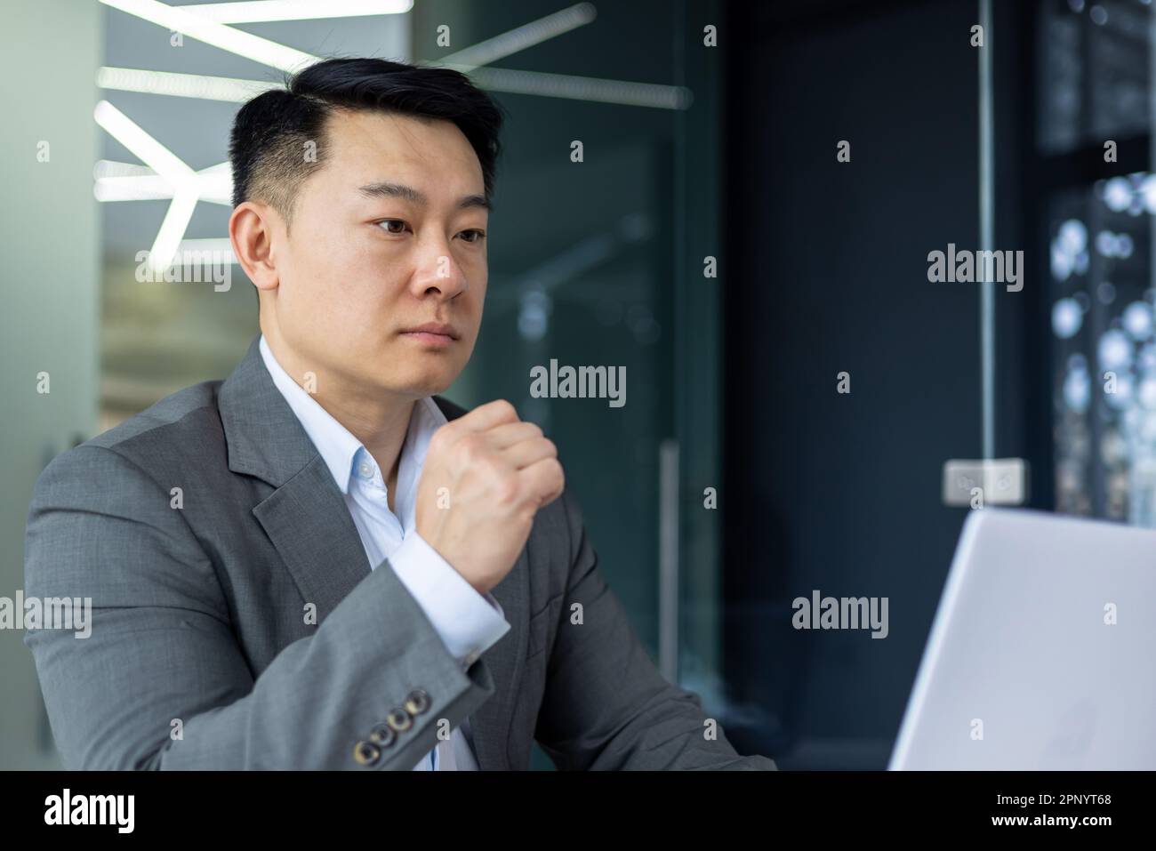 Close up of thinking asian businessman, man in business suit serious ...