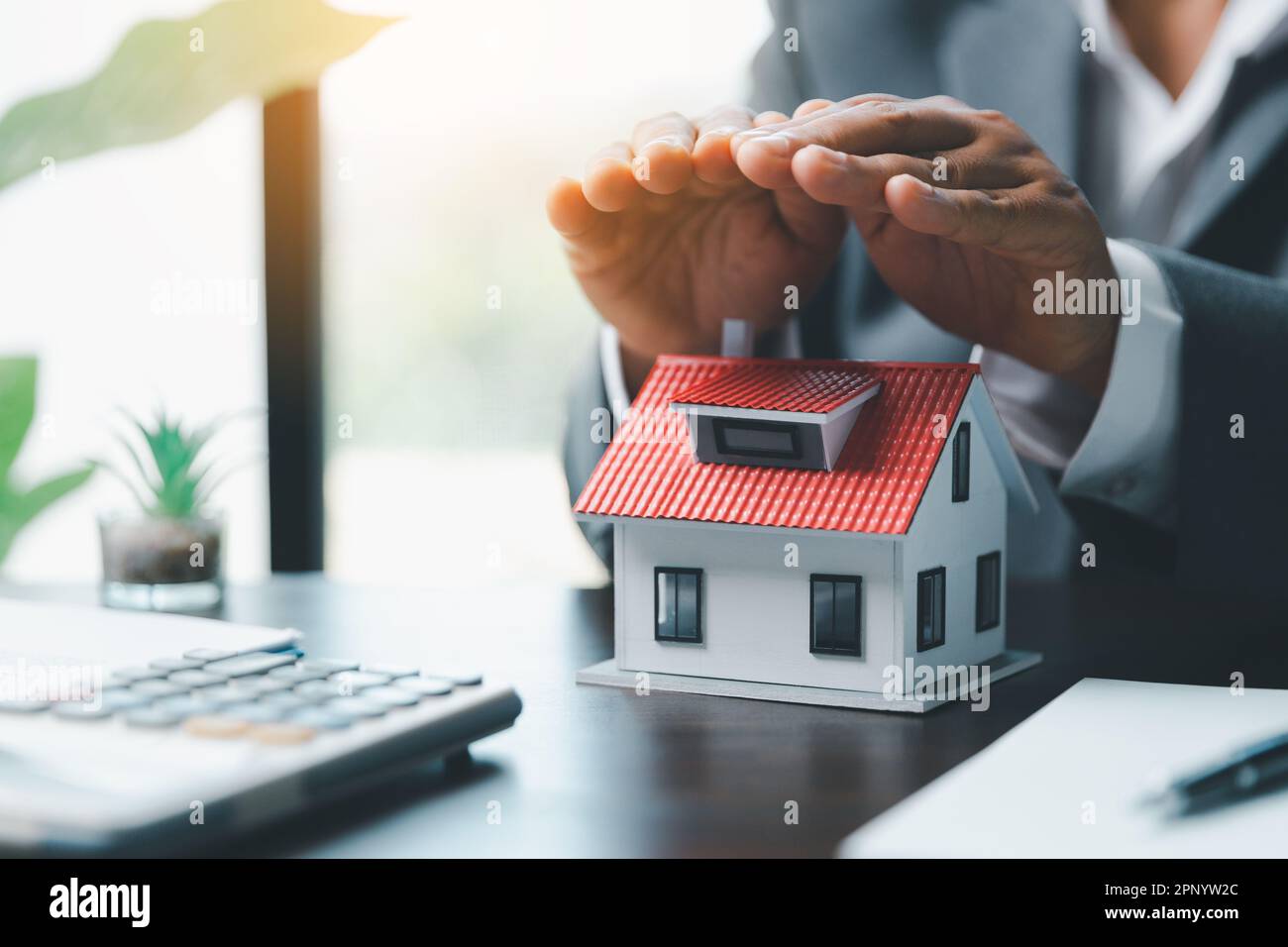 Female hands saving small house with a roof. insurance protective hand ...