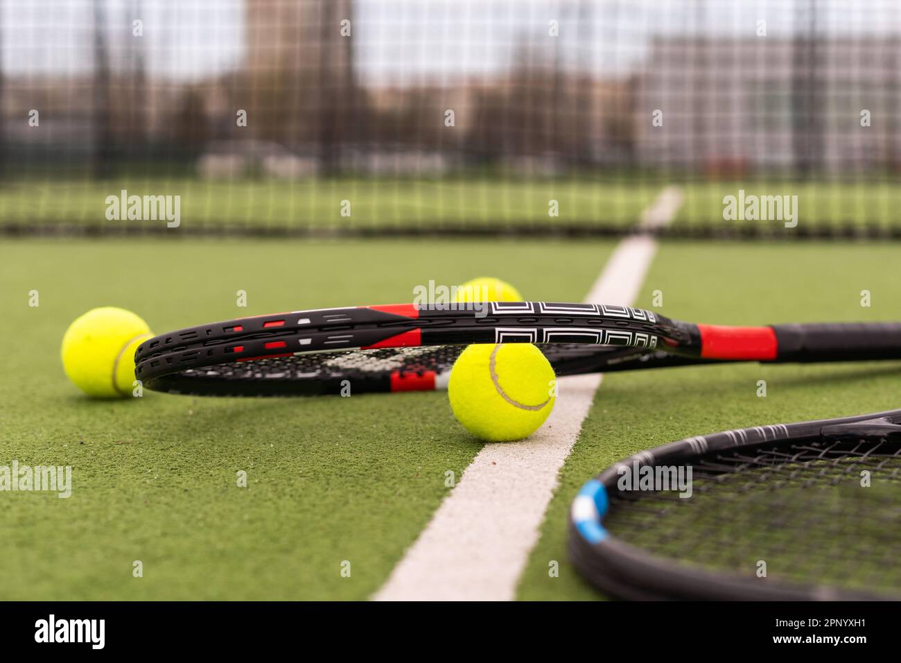 Tennis racket and tennis ball on court Stock Photo - Alamy